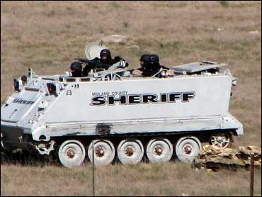 Images Show Cops Well-Armed On Sect Raid - CBS News