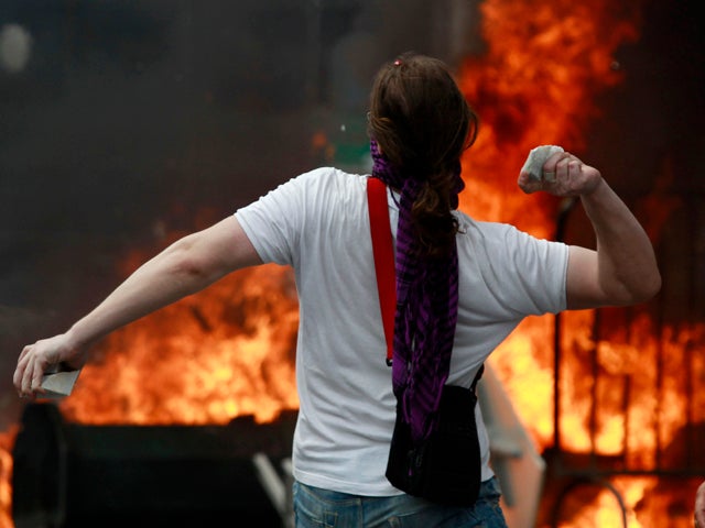 Greek protesters clash with riot police; 66 hurt - CBS News