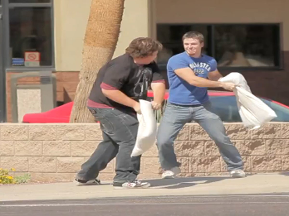 Random pillow fight breaks out on the streets - CBS News
