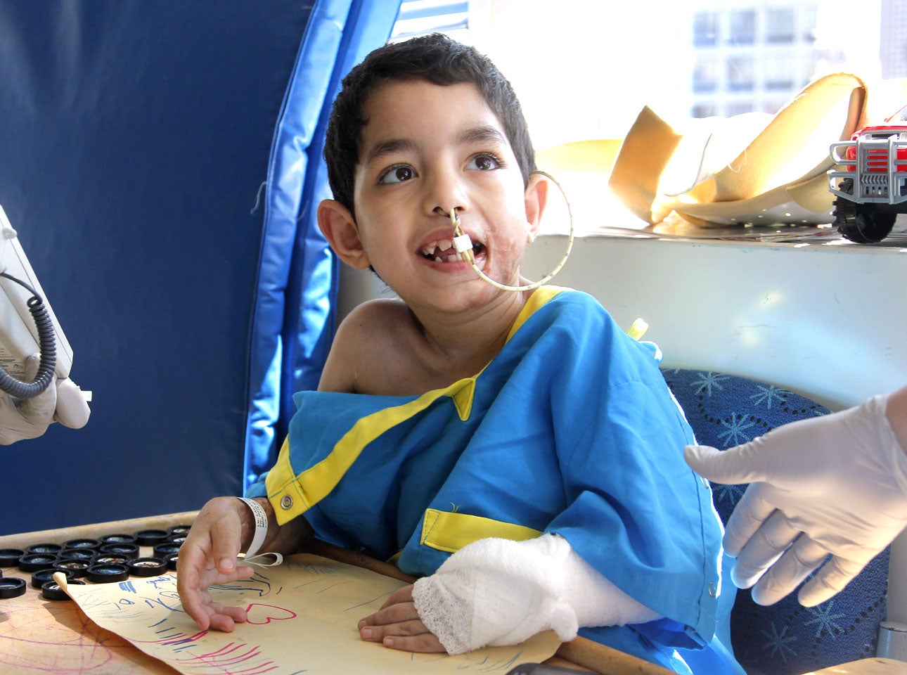 Burned orphan with murky history gets U.S. help - CBS News