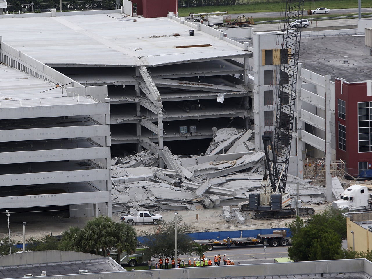 Worker freed from rubble of parking garage collapse - CBS News