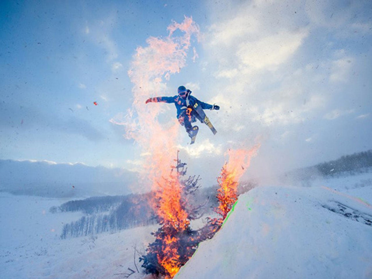 Fire and ice: Snow jumping over flaming trees - CBS News
