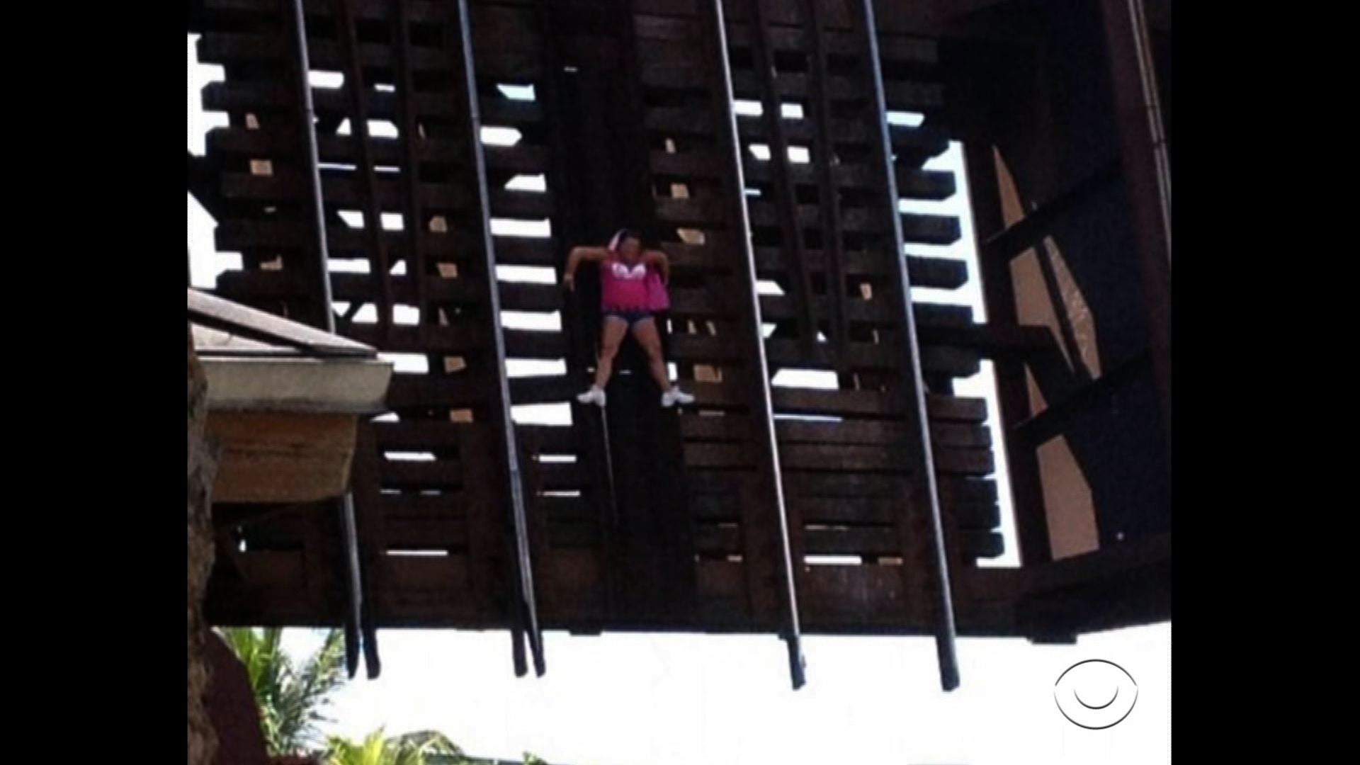 Woman rescued after dangling from railroad bridge - CBS News