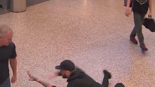 Violent confrontation between passengers caught on airport video - CBS News
