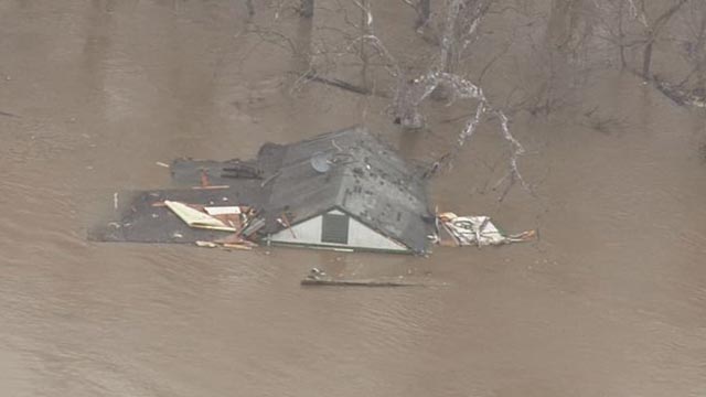 Rescue crews race against rising floodwaters in Midwest - CBS News