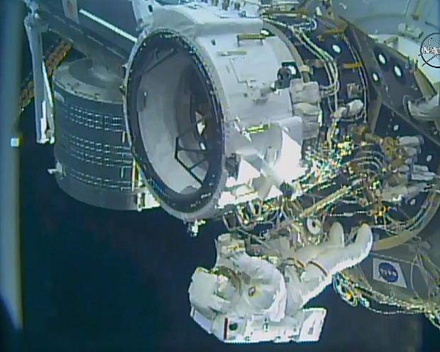 Spacewalkers attach new docking port to station - CBS News