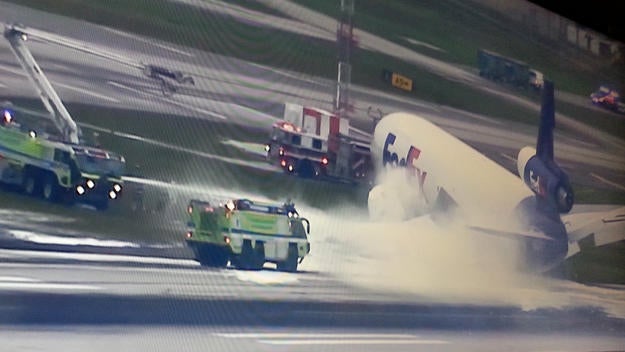 FedEx plane catches fire on runway in Florida - CBS News