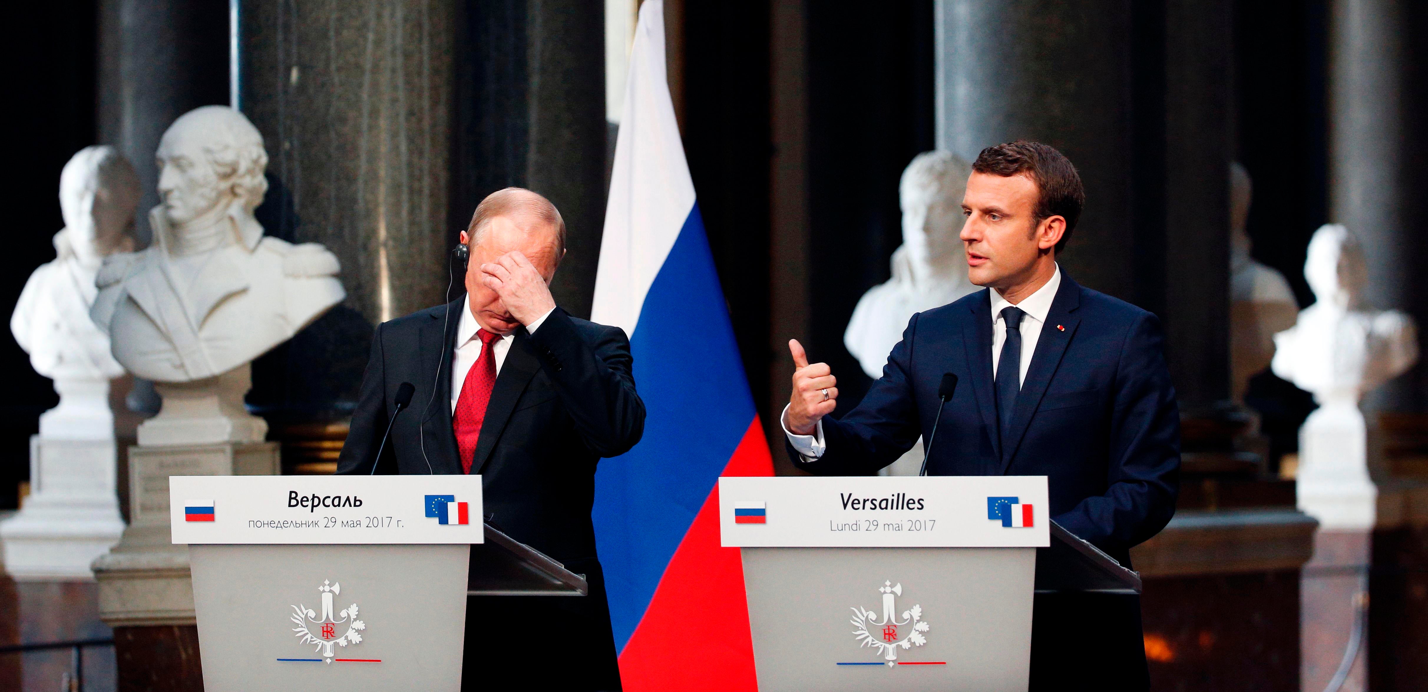 Emmanuel Macron, standing near Putin, attacks Russia outlets - CBS News