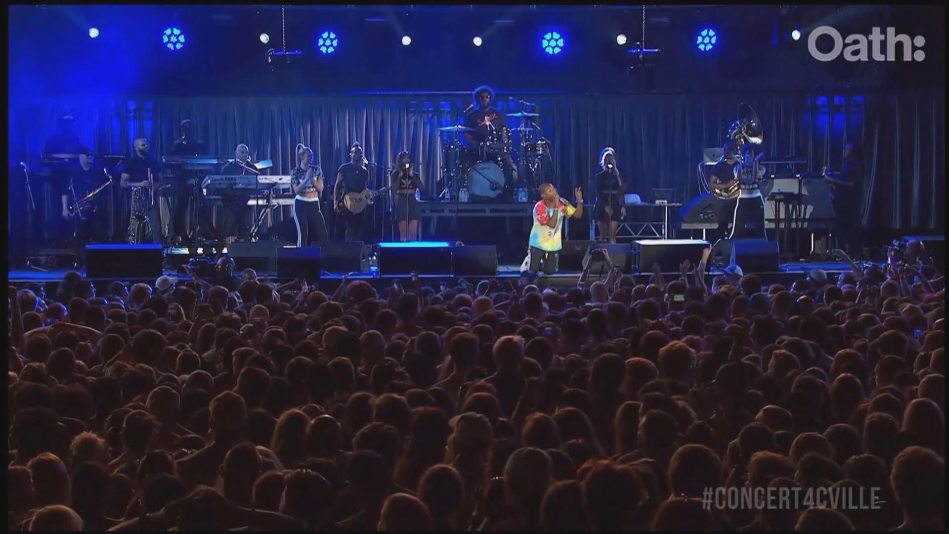 Pharrell Williams, others take knee at Charlottesville concert - CBS News