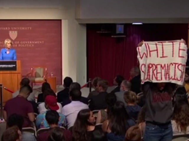 Protests at DeVos Harvard speech: Sign calls her white supremacist ...