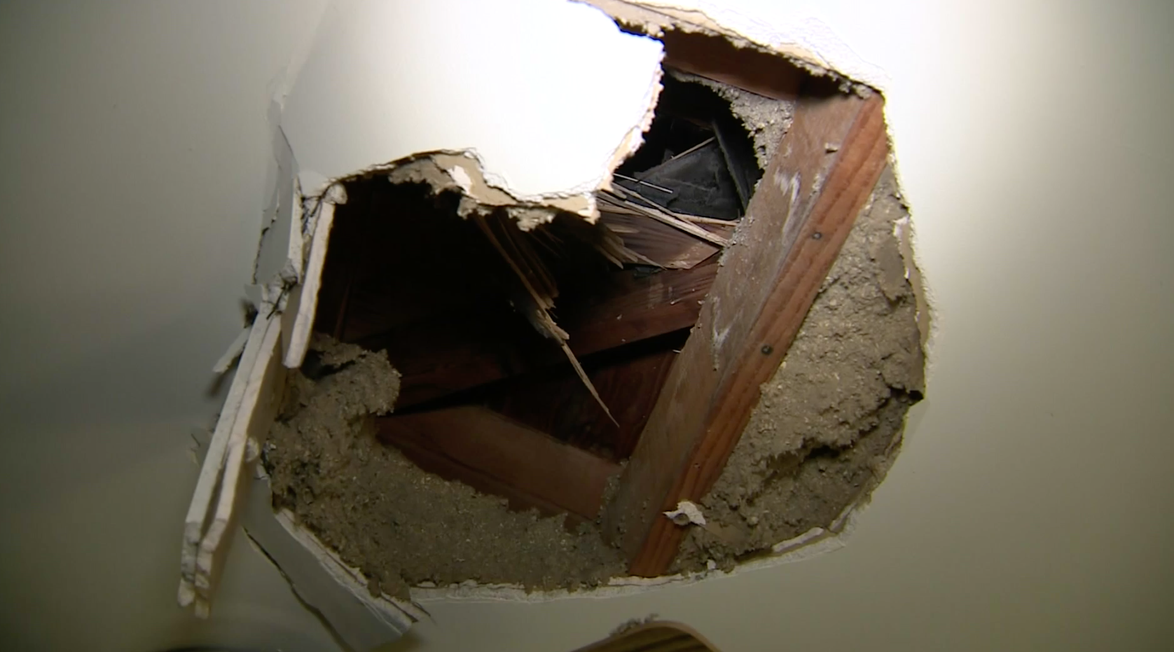 California couple believe ice from plane fell through their roof - CBS News