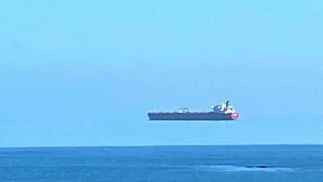 Photos appear to show a giant ship hovering over the water off the ...
