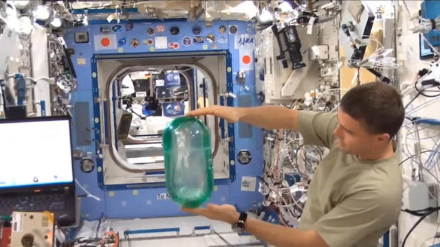 Video shows the weird way water behaves in space - CBS News