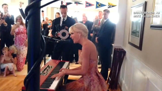 Taylor Swift performs surprise show at fan's wedding - CBS News