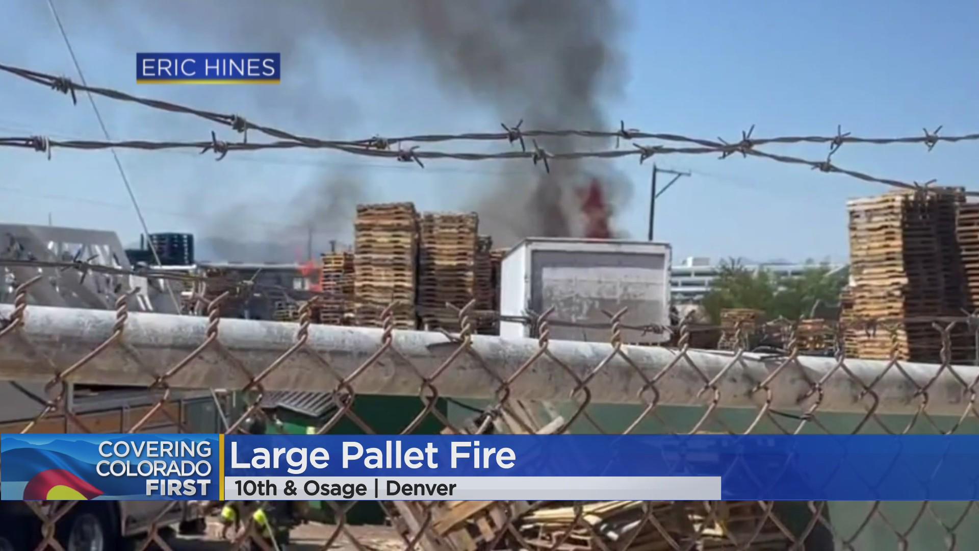 Pallet fire extinguished near light rail tracks in Denver - CBS Colorado