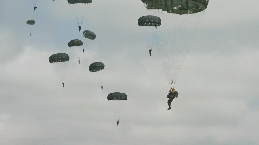 D-Day paratroopers honored by thousands, including CBS News' Charlie D'Agata, reenacting a leap ...