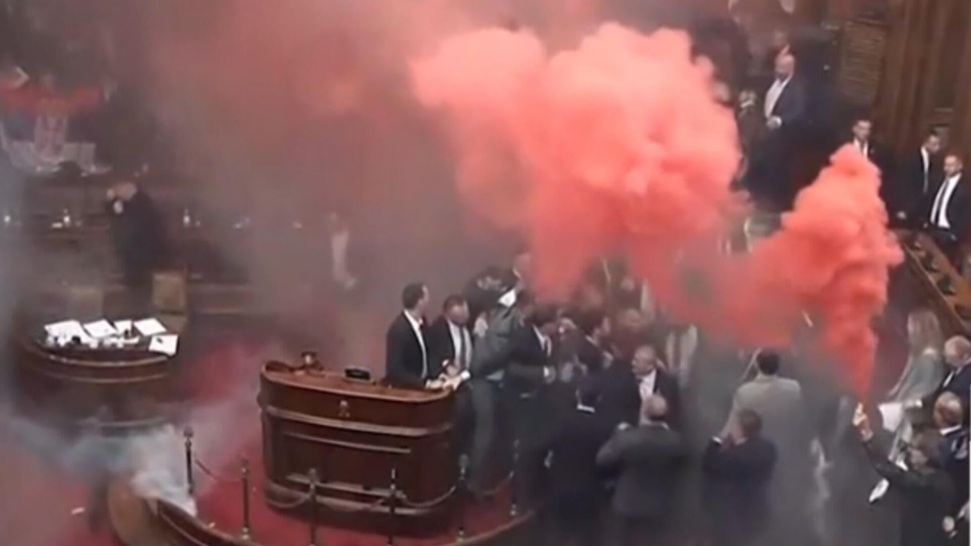 At least 3 lawmakers injured as smoke bombs and flares are thrown in Serbian parliament - CBS News