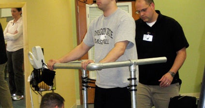 Paralyzed man stands up thanks to new therapy - CBS News