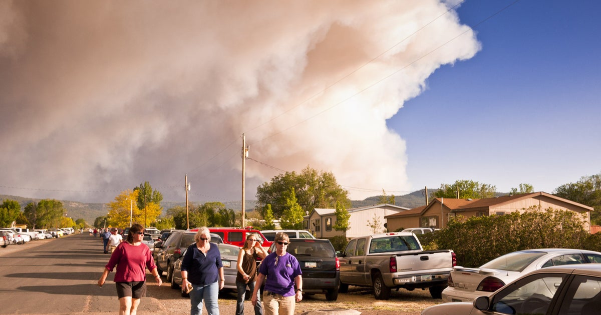 Arizona wildfire burns cabins, forces evacuations - CBS News