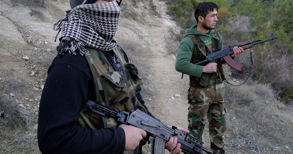 Syria activist: "Organized massacre" kills dozens - CBS News