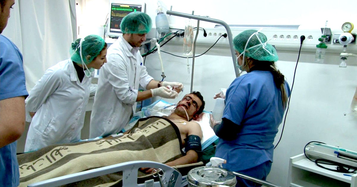 Visit to military hospital shows extent of Syrian conflict - CBS News