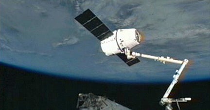 Dragon cargo ship captured, berthed at space station - CBS News