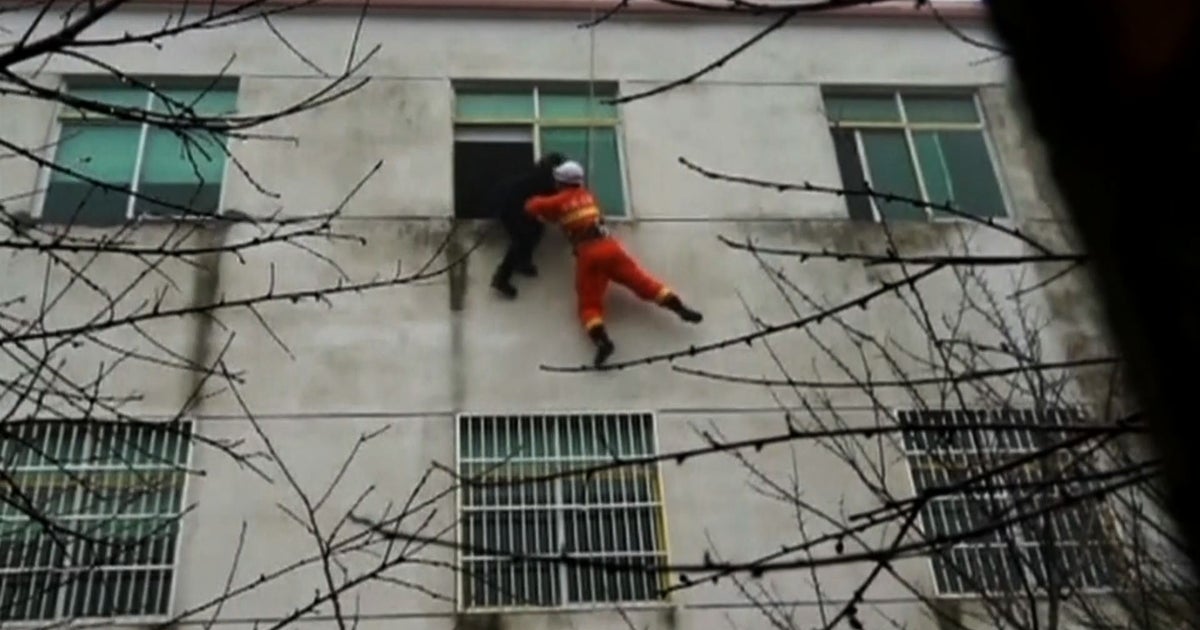 Watch: Rescue of would-be jumper from 3rd story window - CBS News
