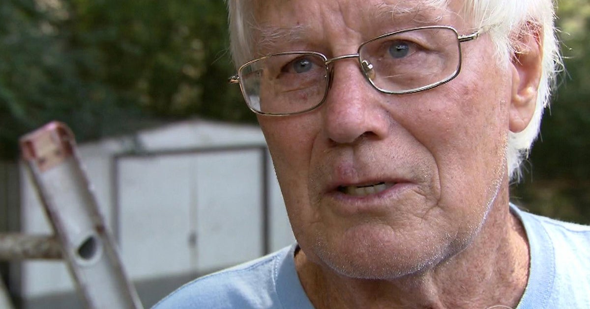 Senior citizen David Case returns to slosh through his water-ravaged ...