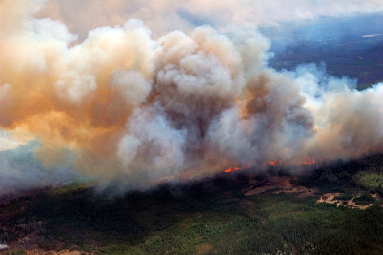Crews race against time battling enormous Canada wildfire - CBS News