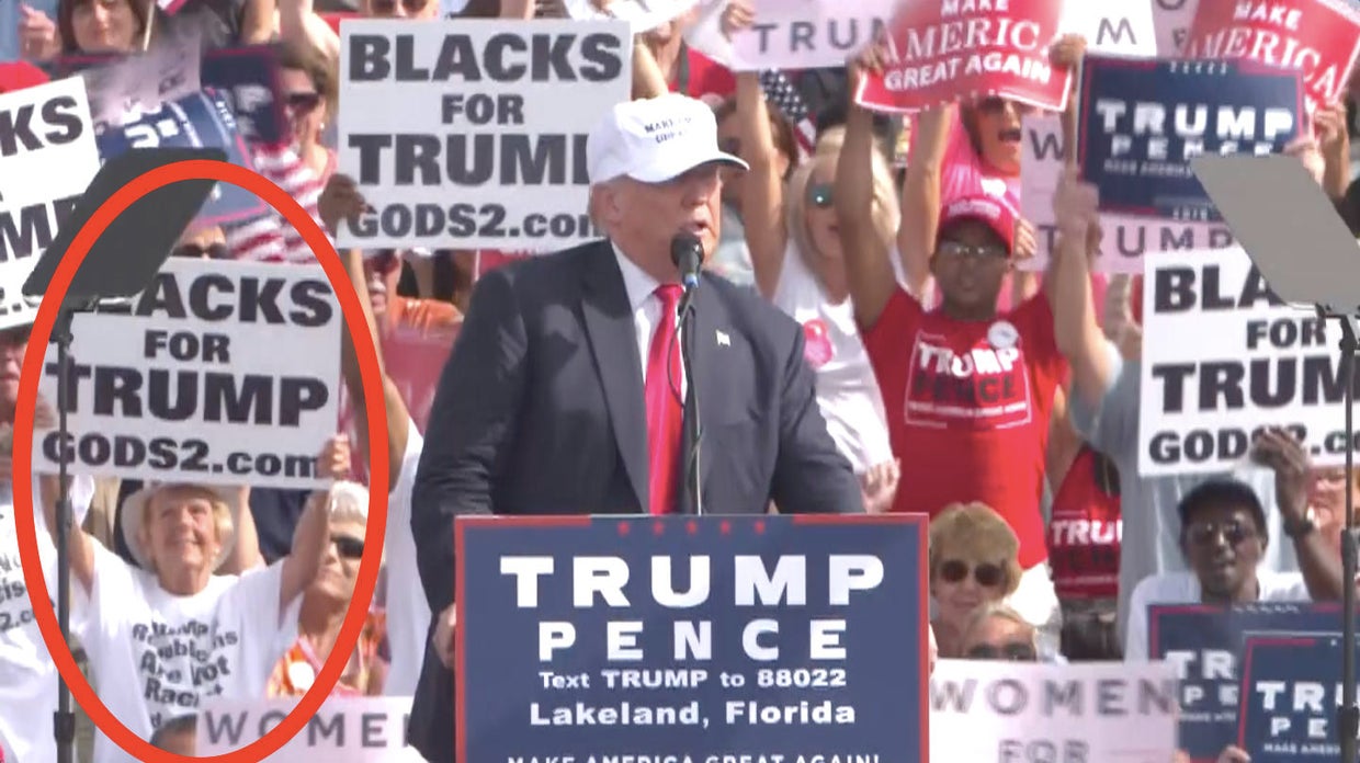White woman holds "Blacks for Trump" sign at Florida rally - CBS News