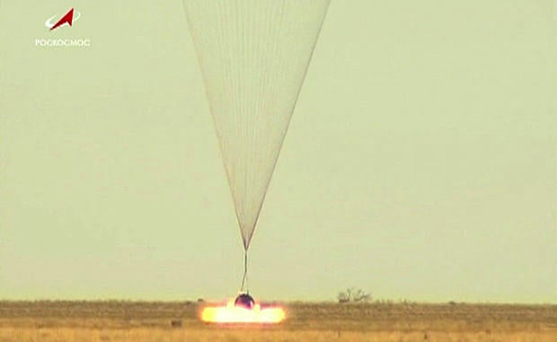Soyuz capsule brings three station fliers back to Earth after 6 months ...