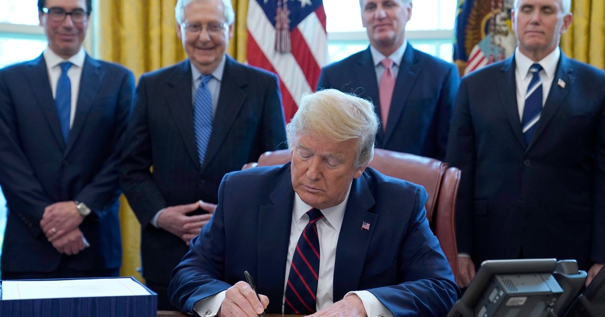 Trump signs massive coronavirus relief package - CBS News