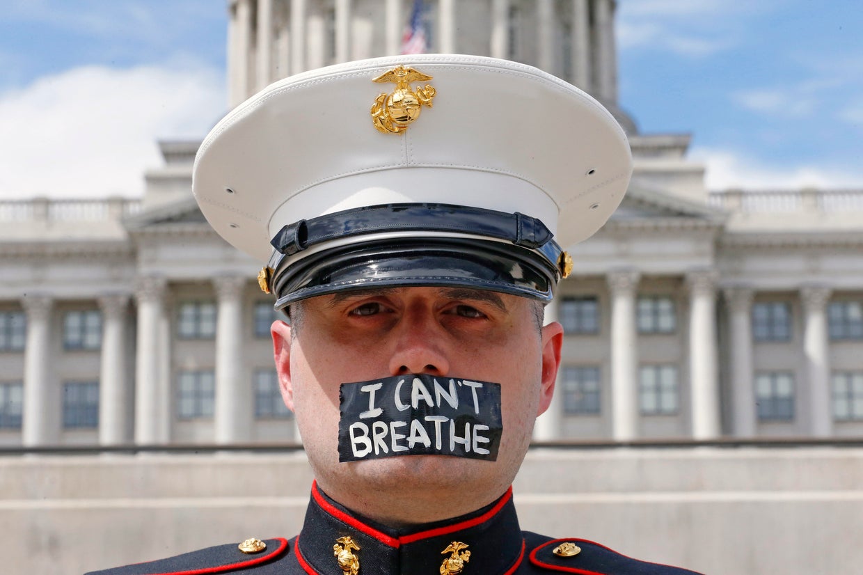 U.S. Marine veteran stands outside in the heat for hours with the words ...