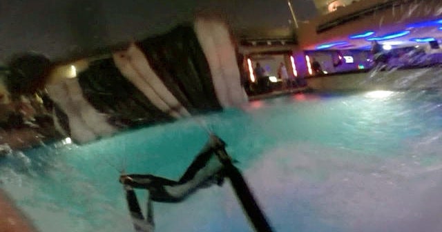 Watch: BASE jumper lands in rooftop pool - CBS News