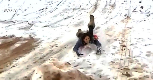 Reporter crashes into massive snowball - CBS News