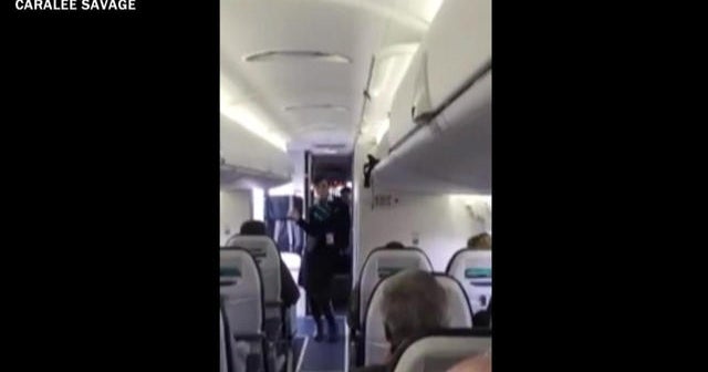Watch flight attendant bust a move as passengers board - CBS News