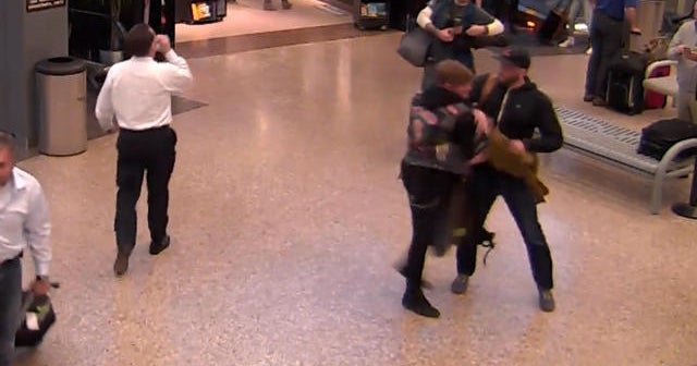 Airport scuffle caught on camera - CBS News