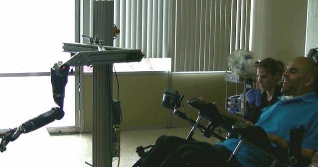 New tech helps quadriplegic control robotic arm with mind - CBS News