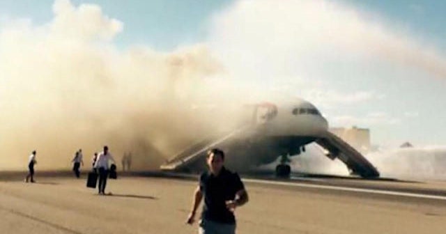 Passengers evacuated from burning plane - CBS News