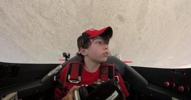 Young boy passes out on board stunt plane - CBS News