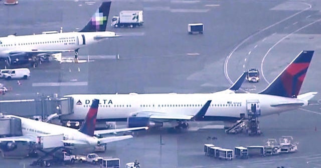 Passenger attacks Delta flight attendant midair - CBS News
