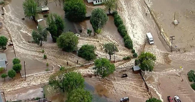 Trapped driver rescued as flash flooding hits California - CBS News