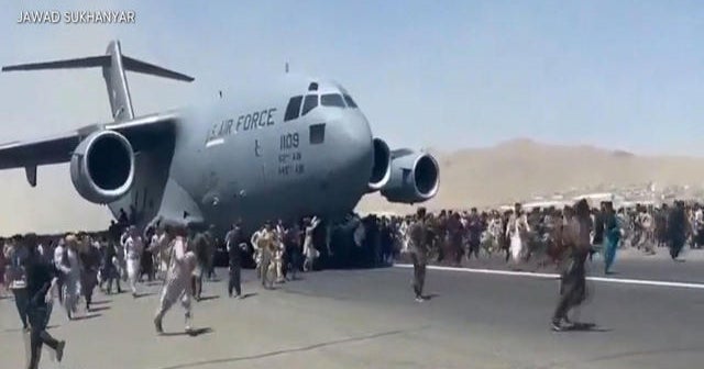 Afghans scramble to flee Taliban takeover - CBS News