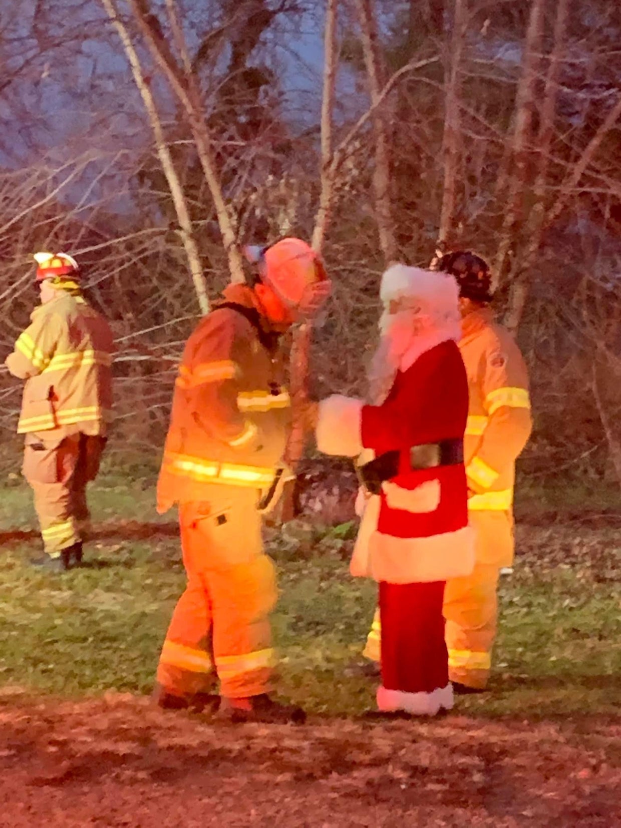 Santa Claus was touring a town with firefighters when they saw a house ...