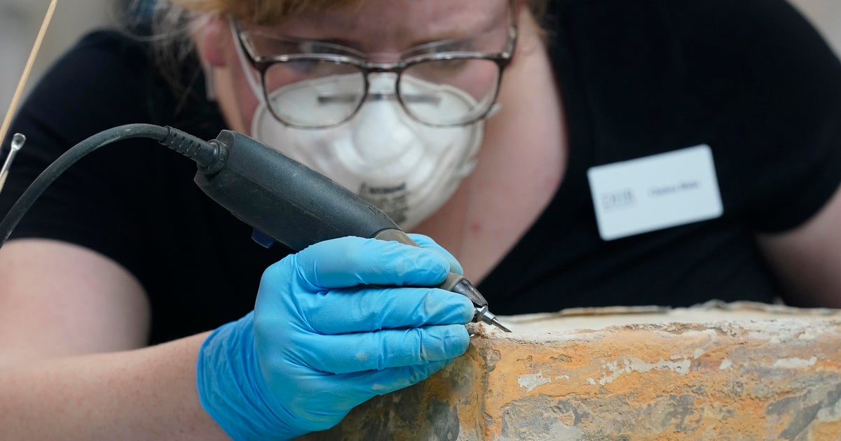 Books, envelope and silver coin found in time capsule beneath former ...
