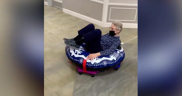 Seniors go snow tubing inside their senior living home - CBS News