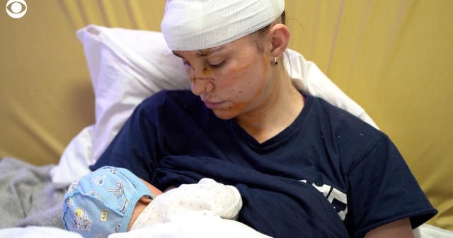 Ukrainian mom shields baby from shelling - CBS News