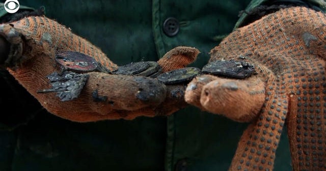 Former USSR soldier displays charred medals after house is shelled ...