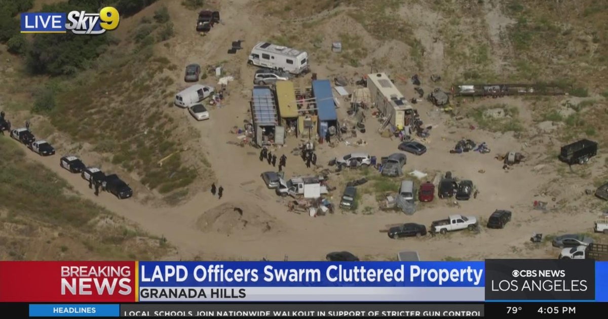 LAPD officers swarm cluttered property - CBS Los Angeles
