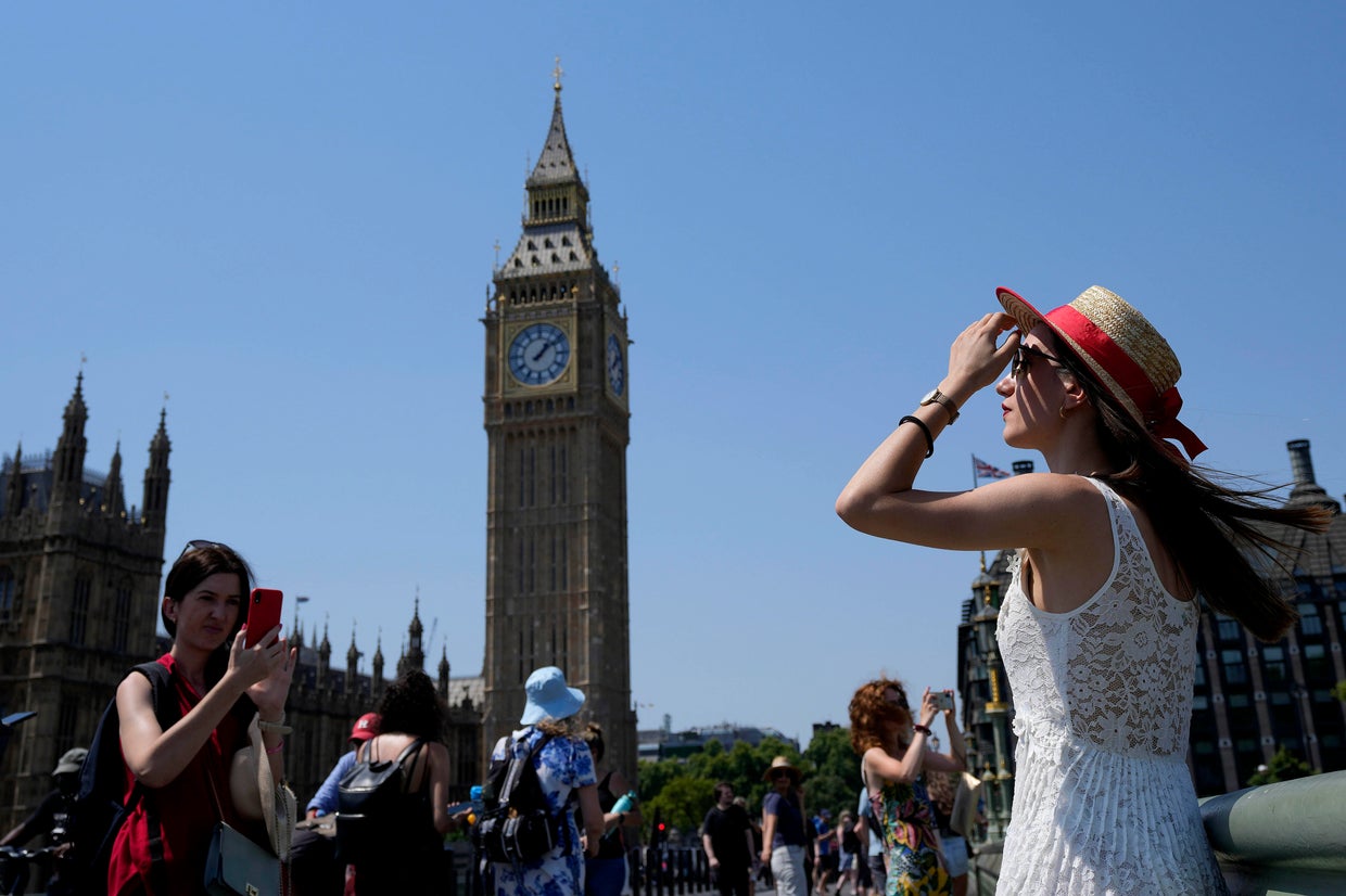 Britain bakes as heat wave brings record high temperatures and fuels ...
